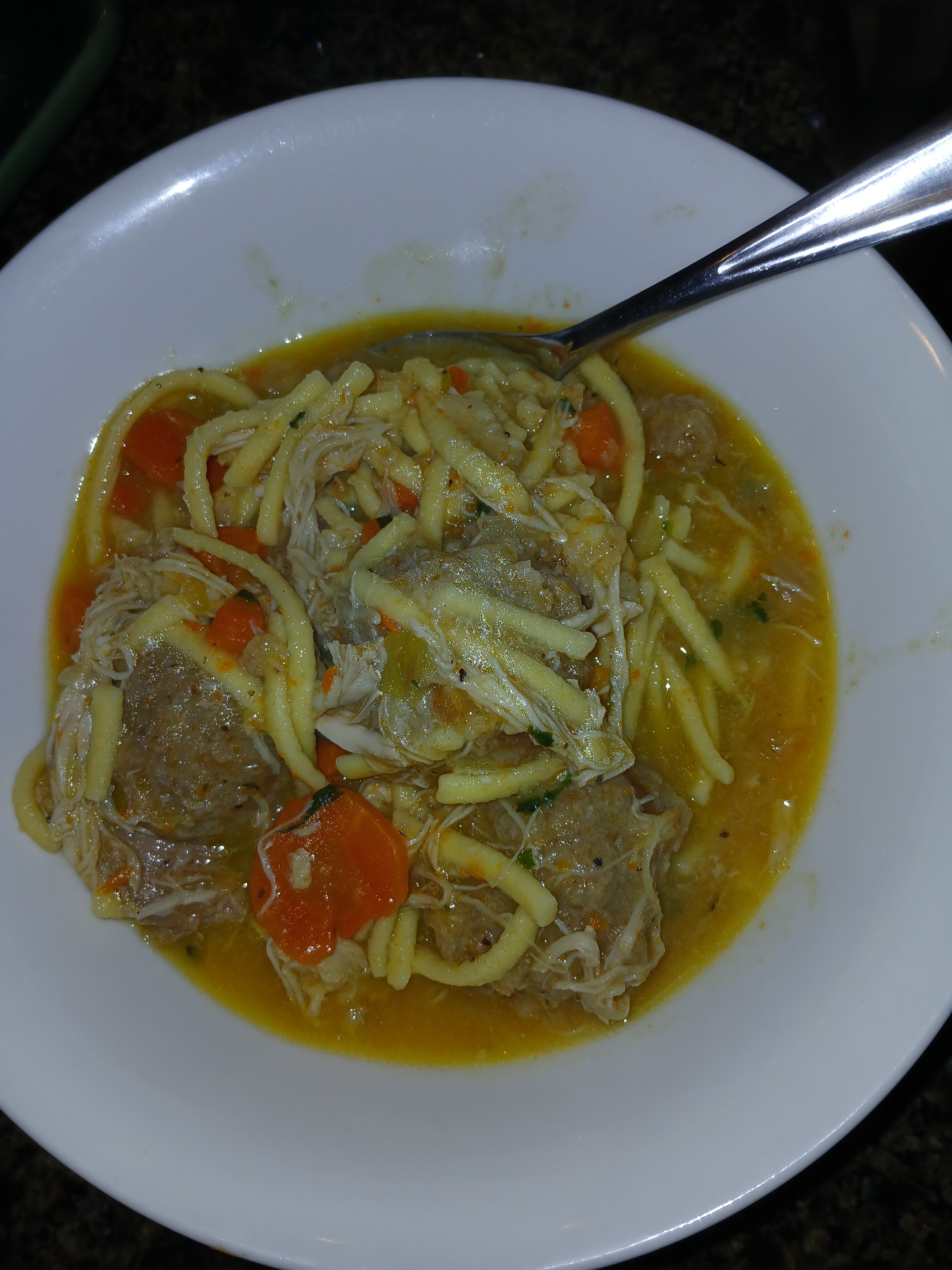 Homemade chicken and spaetzle soup with German butterballs, afte